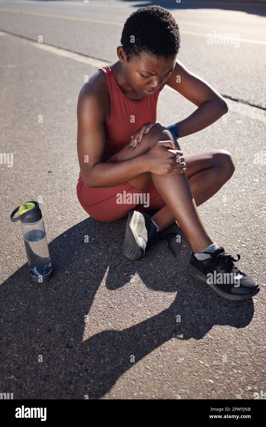 Fitness, knee and black woman injury, after training and workout with ...