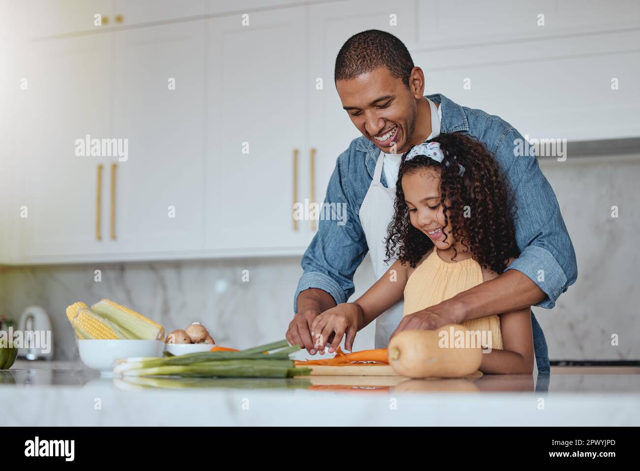 Love, father and girl cooking food with healthy vegetables for lunch or ...