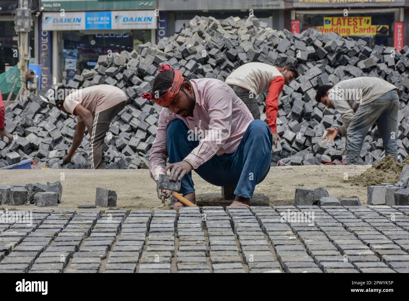 Srinagar, India. 01st May, 2023. Labourers work at a construction ...