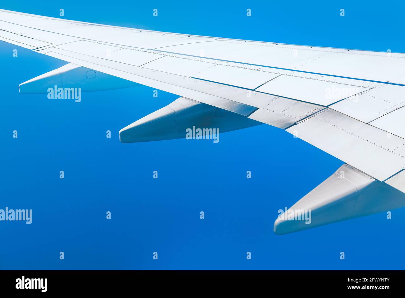 Aircraft wing in flight . Plane wing at blue sky Stock Photo - Alamy