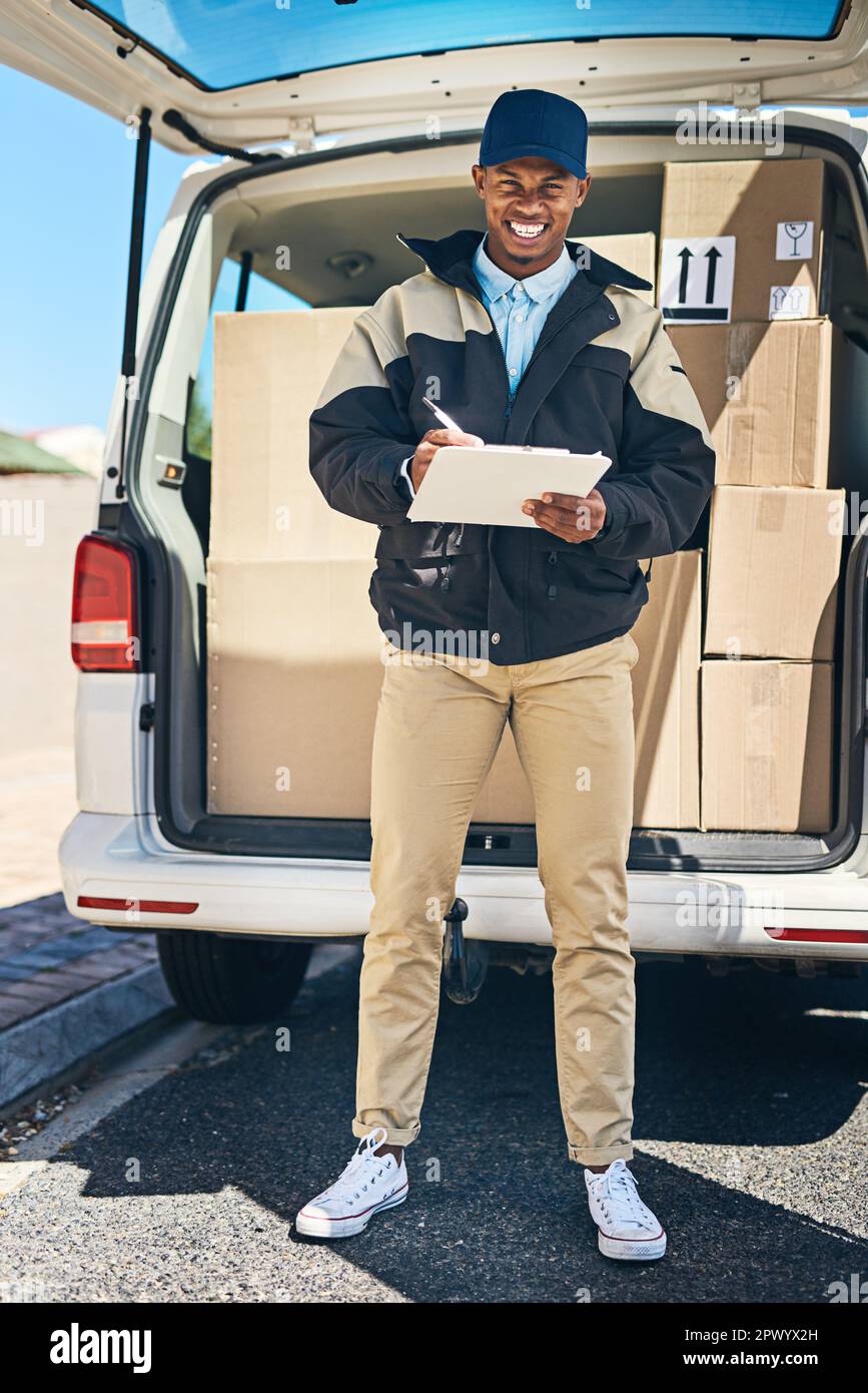 Delivery man reporting for duty. Portrait of a courier checking the ...