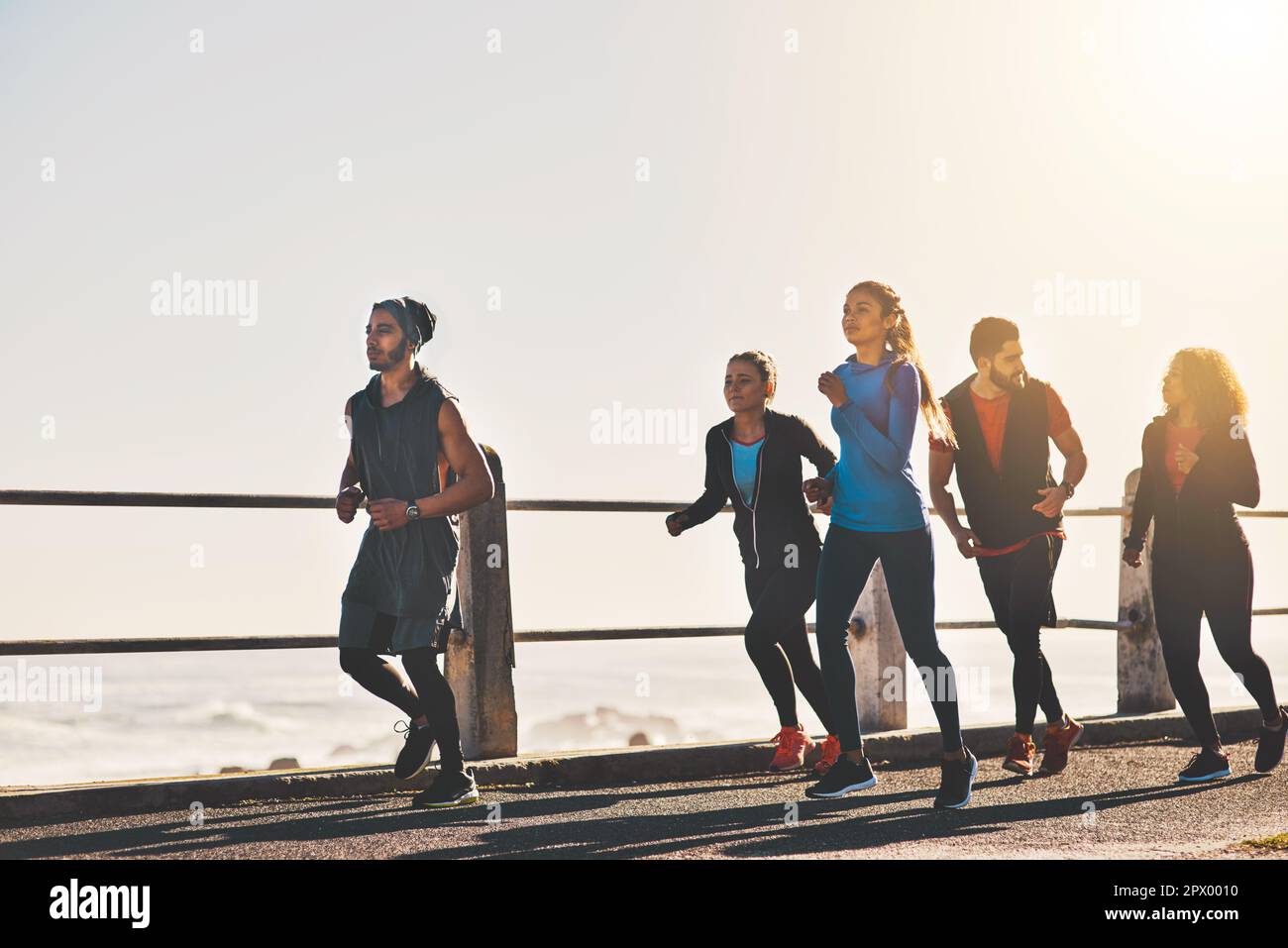 Together we stick to our workout routine. a fitness group out running ...