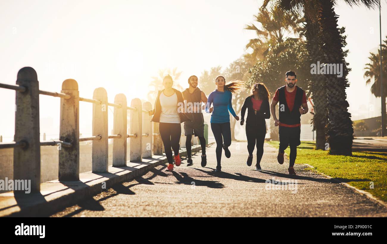 We help each other to get fitter. a fitness group out running on the ...