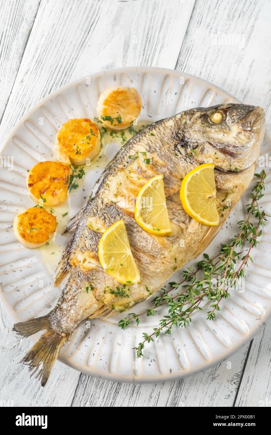 Mediterranean Baked Sea Bream Dorada fish with scallops and thyme Stock ...