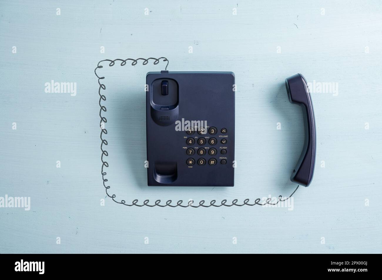 Top view of a classical black landline telephone with handset off the ...