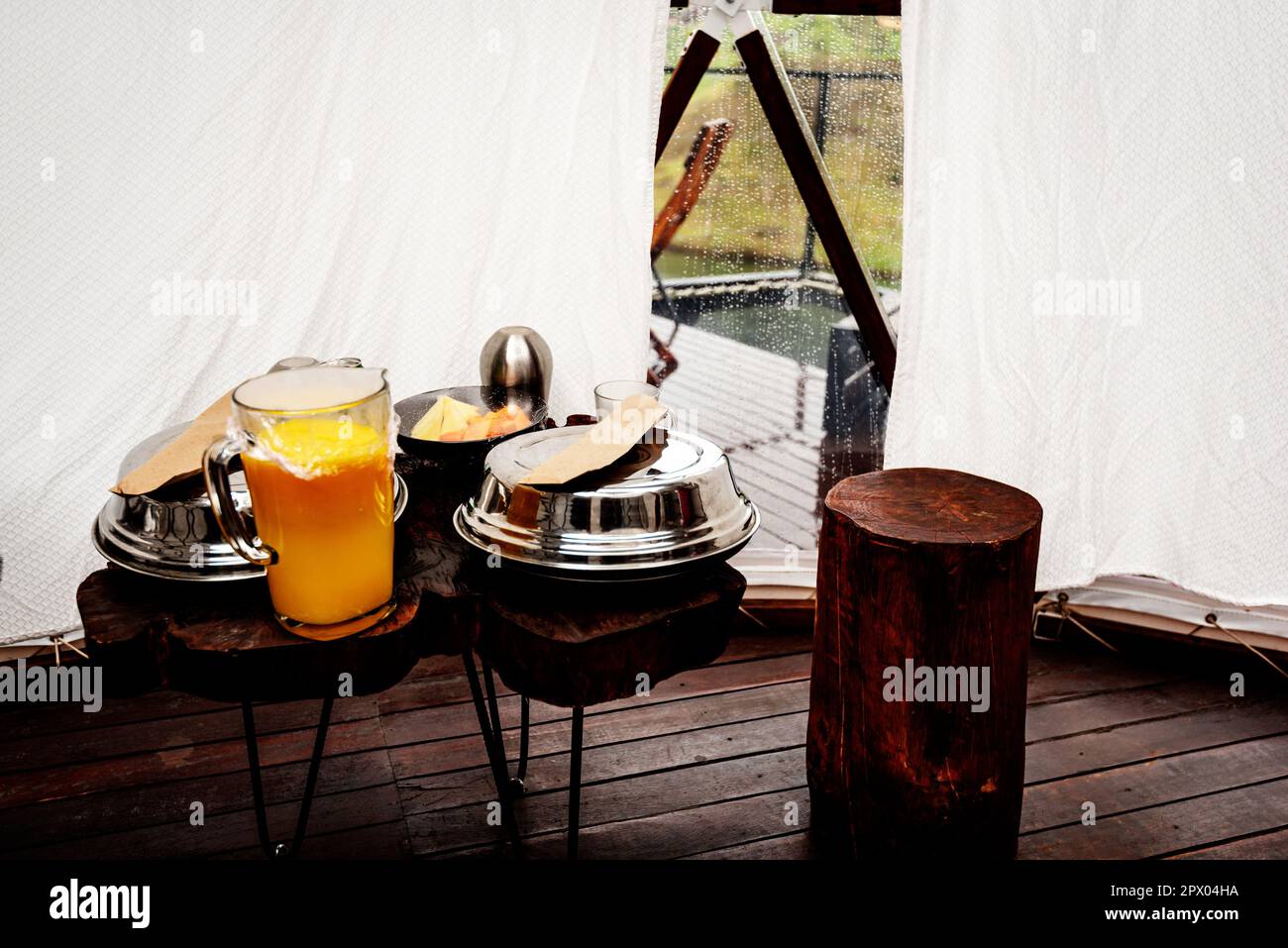Room service breakfast served inside luxury glamping tent a rainy ...