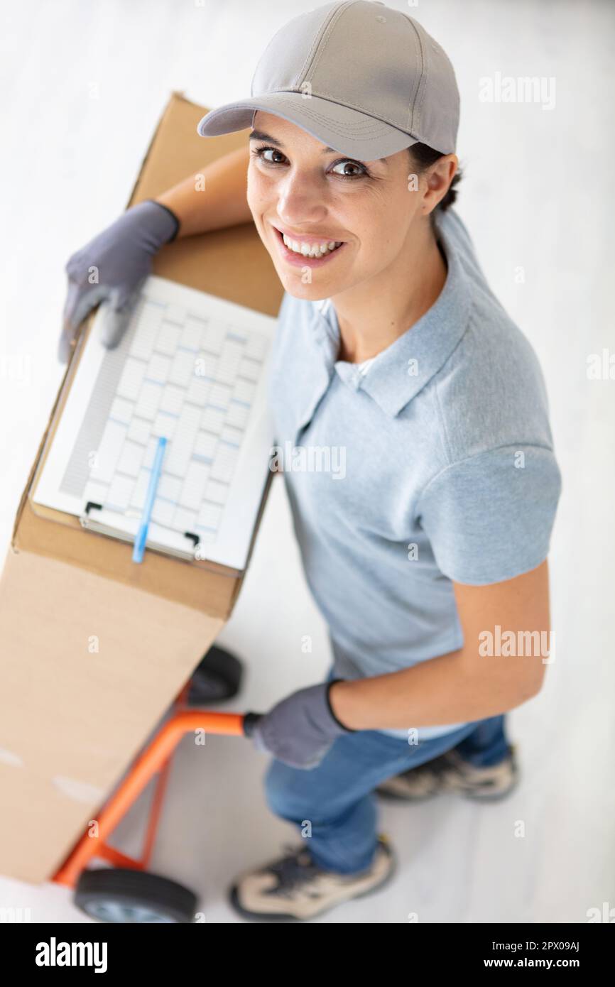 female delivery worker with hand truck Stock Photo - Alamy