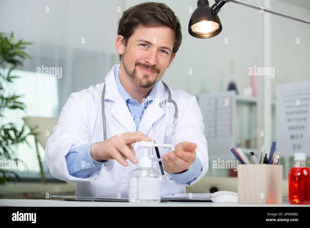 doctor actioning pump dispenser of antibacterial handwash Stock Photo ...