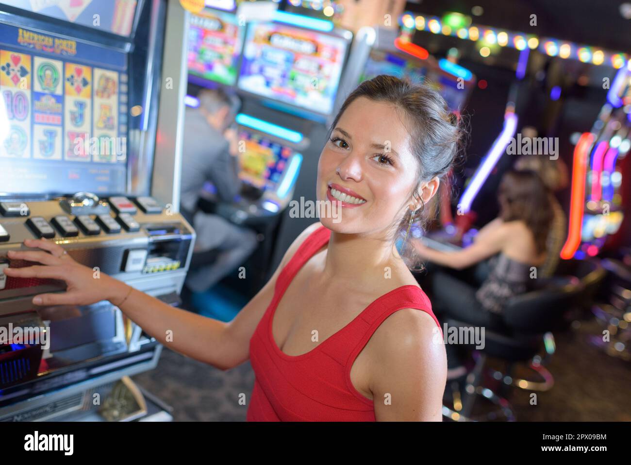 portrait of woman at arcade machine Stock Photo - Alamy
