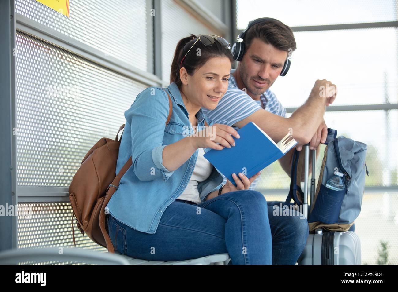 two laughing people chatting at bus stop Stock Photo - Alamy