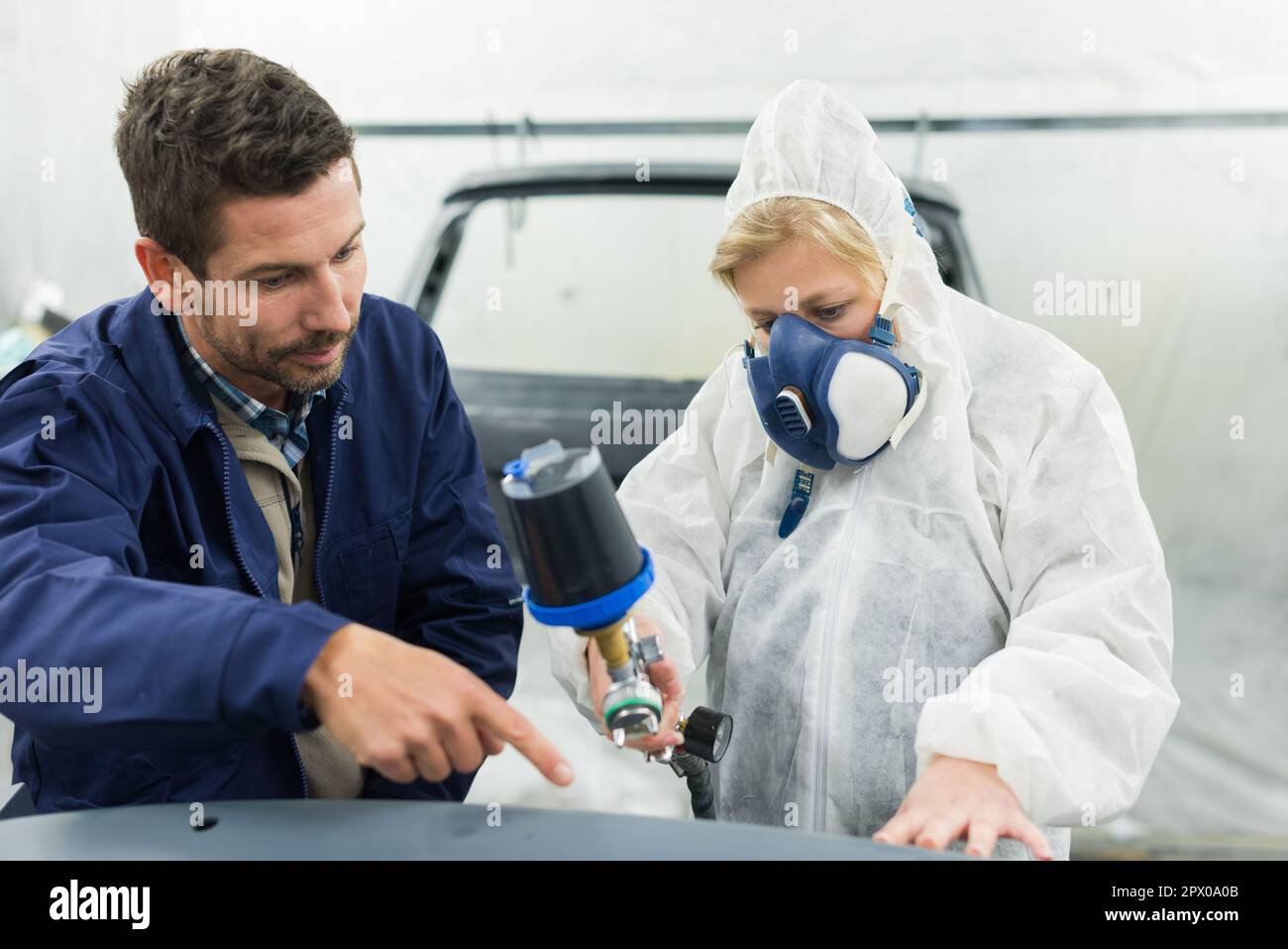 female repairman painter painting automobile car Stock Photo - Alamy