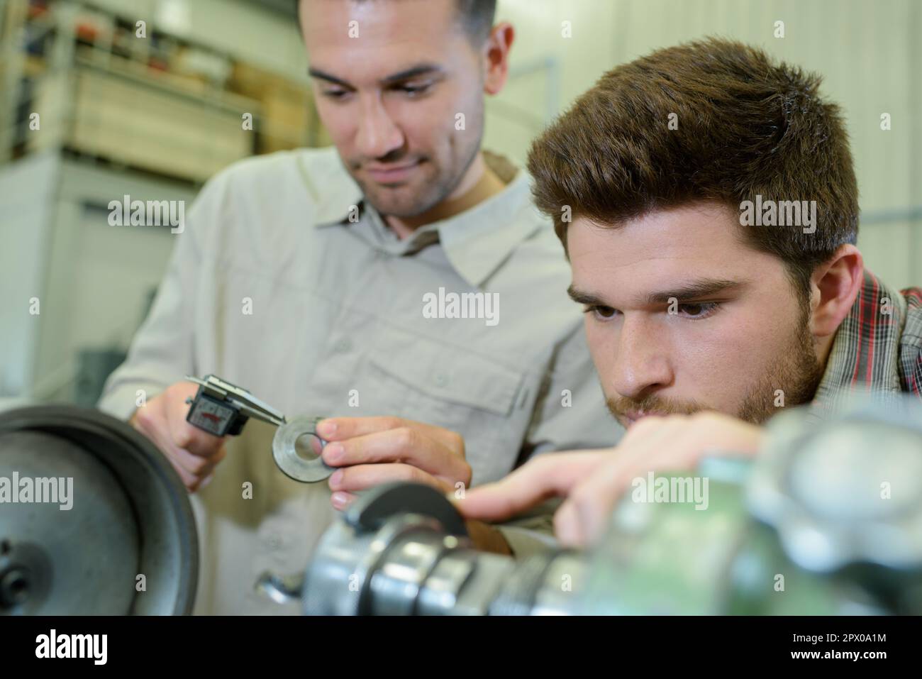 young man in technical vocational training with teacher Stock Photo - Alamy