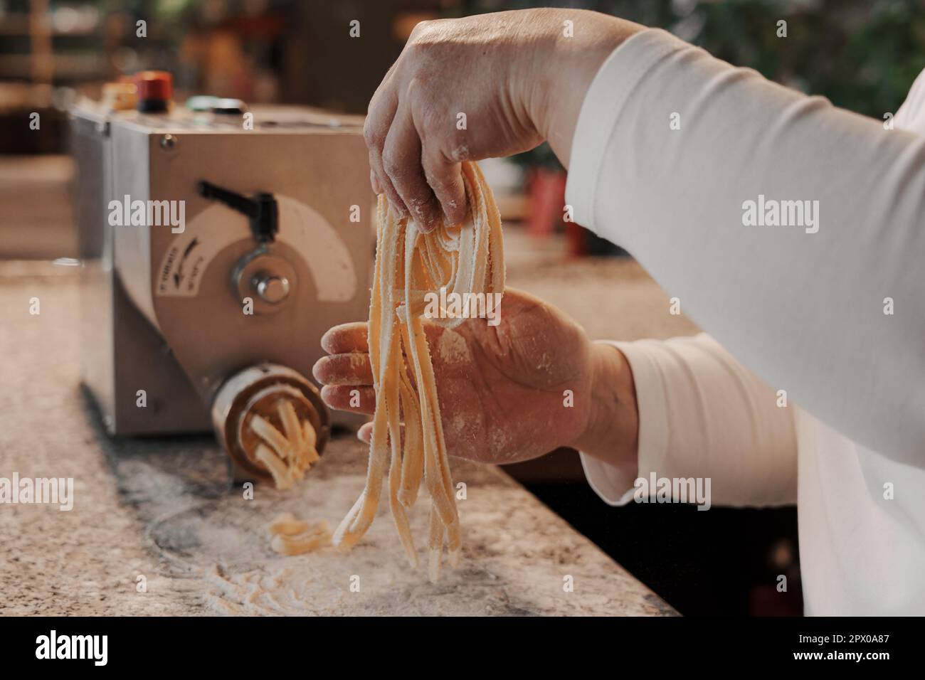 Crop female cook rolling uncooked pasta dough Stock Photo - Alamy