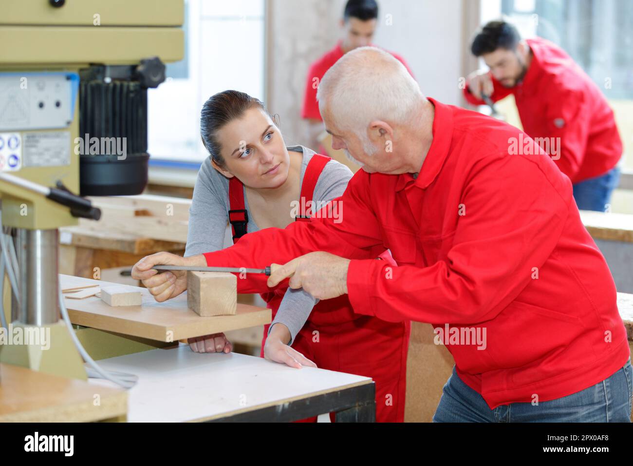supervisor teaching female apprentice to use file Stock Photo - Alamy