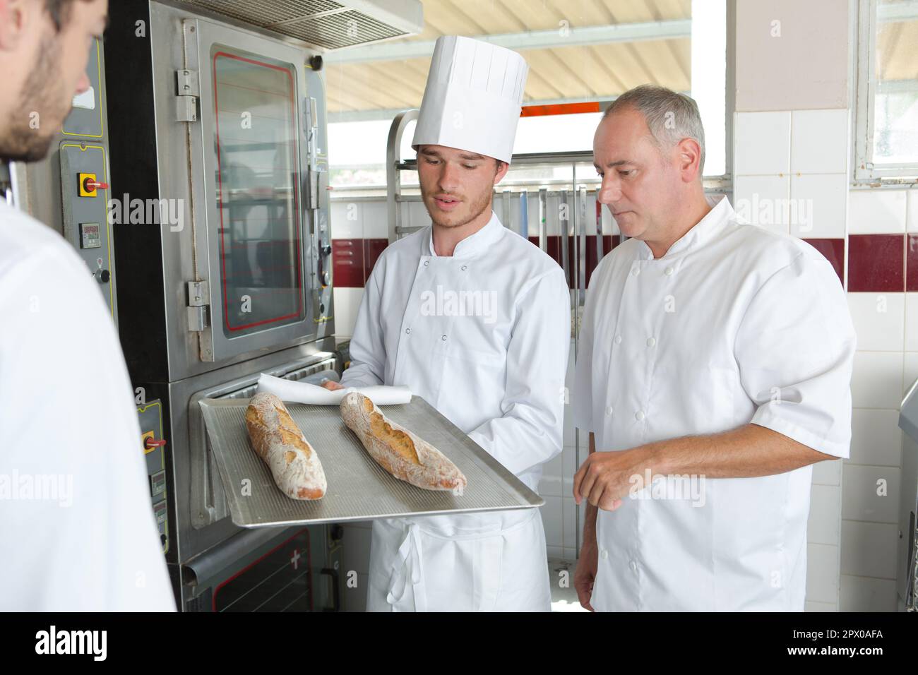 young apprentices is proud of his first time in bakery Stock Photo - Alamy