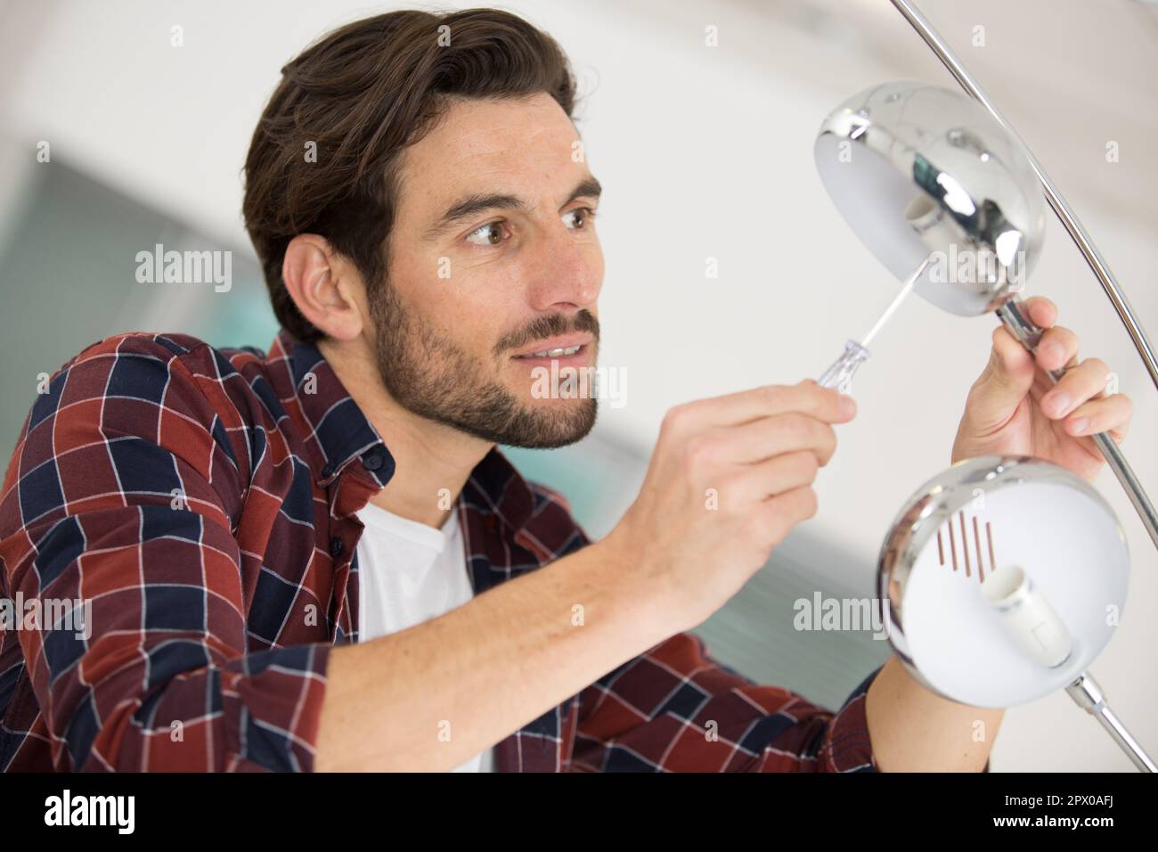 man fitting a new bulb in a lamp Stock Photo - Alamy
