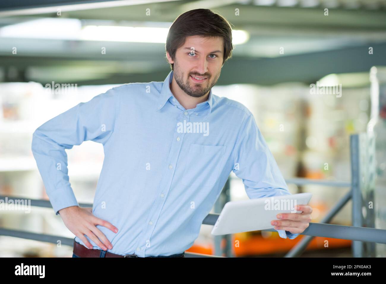 portrait of smiling factory worker using a tablet in factory Stock ...