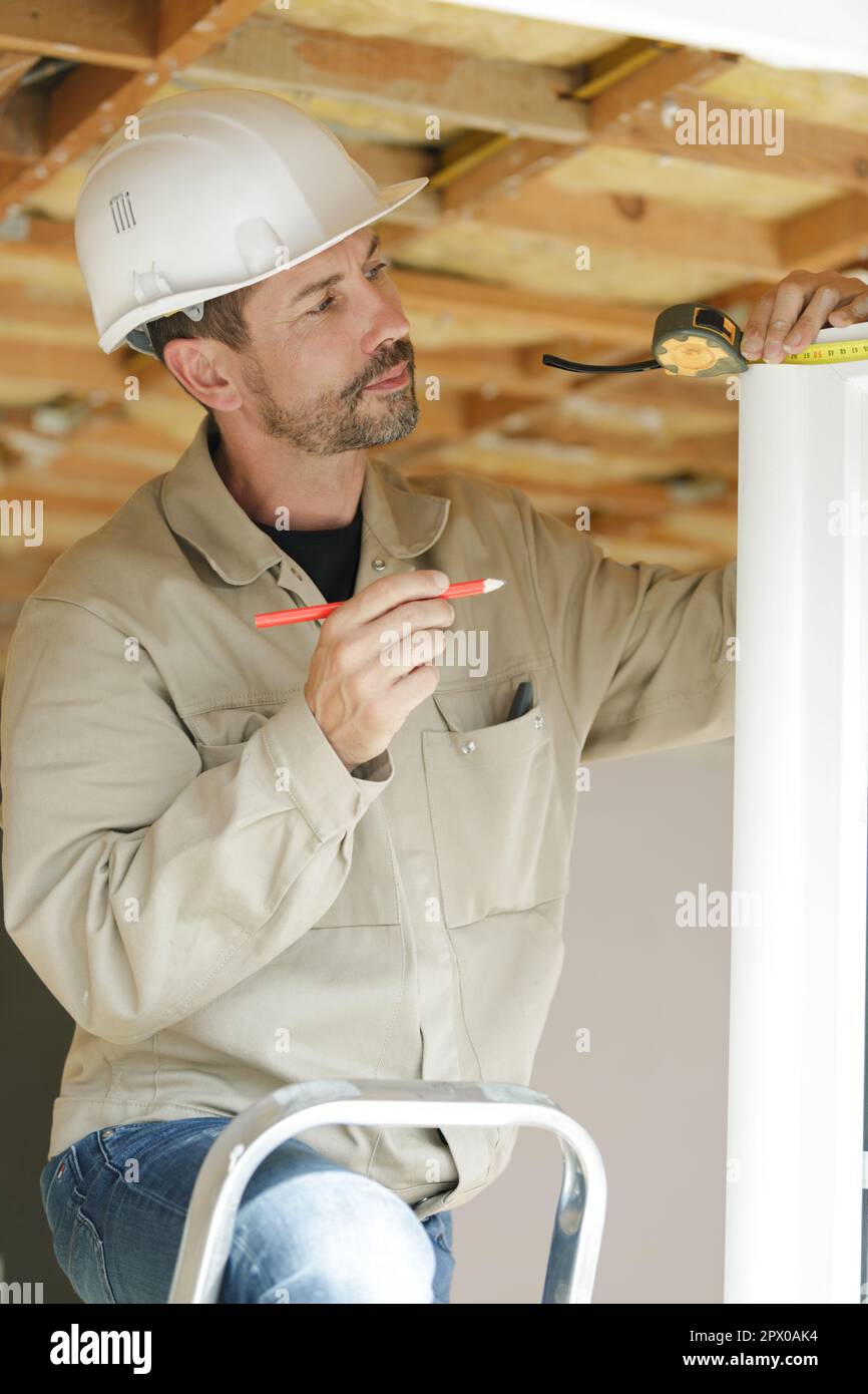 a technician measuring a window Stock Photo - Alamy