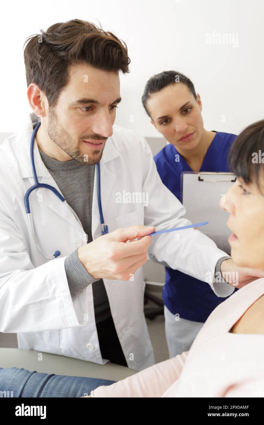 doctors checking patients health during consultation Stock Photo - Alamy