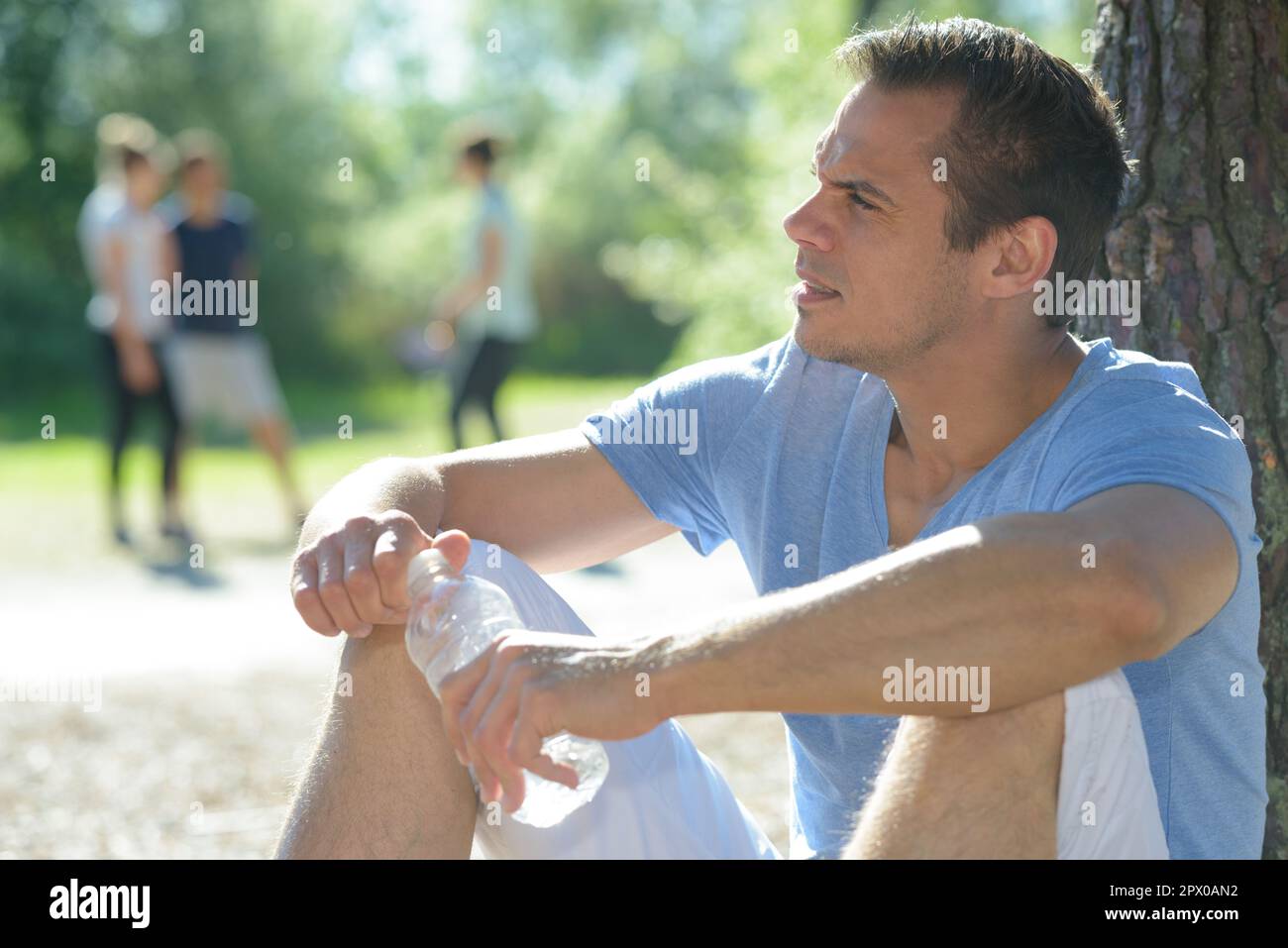 man relaxing by tree on a fall journey Stock Photo - Alamy