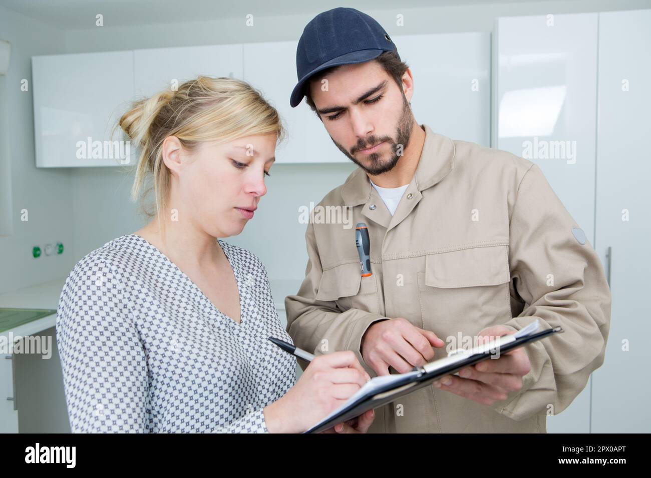 woman writing on worker clipboard Stock Photo - Alamy