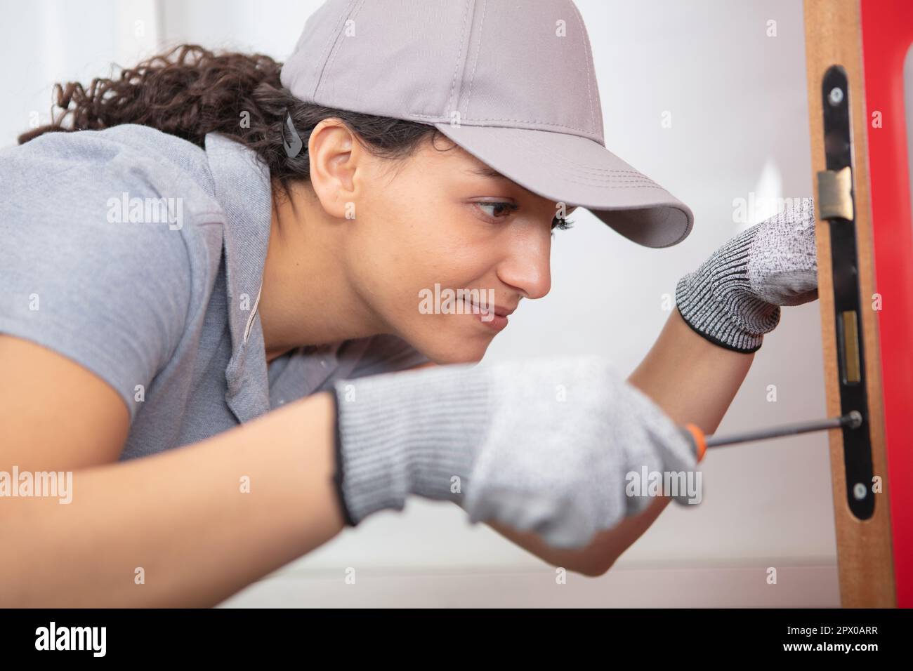 Woman locksmith fixing lock hi-res stock photography and images - Alamy