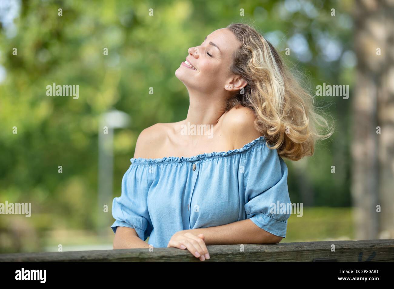 young pretty girl with hair blowing in the wind outside Stock Photo - Alamy