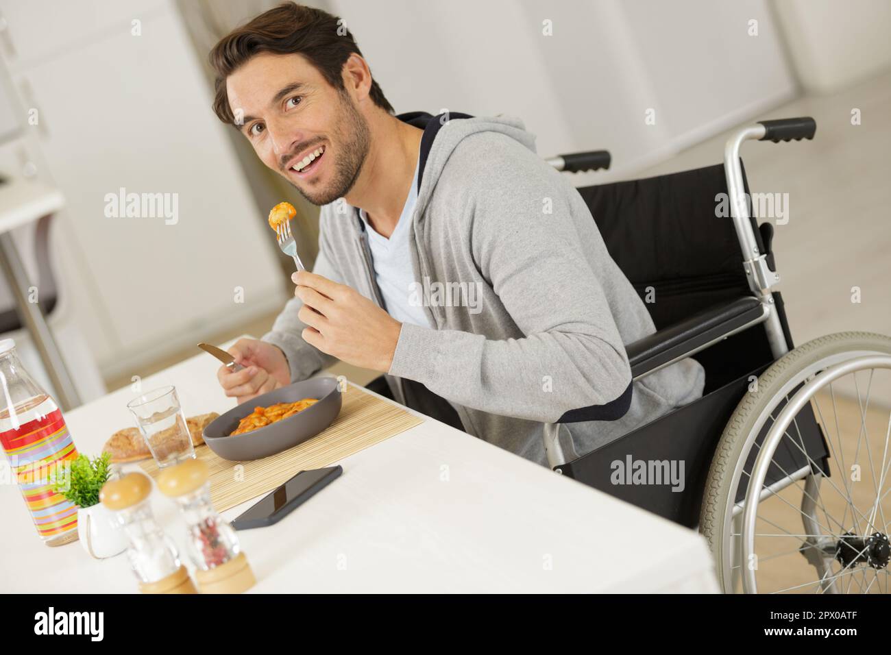 disabled young man having lunch Stock Photo - Alamy