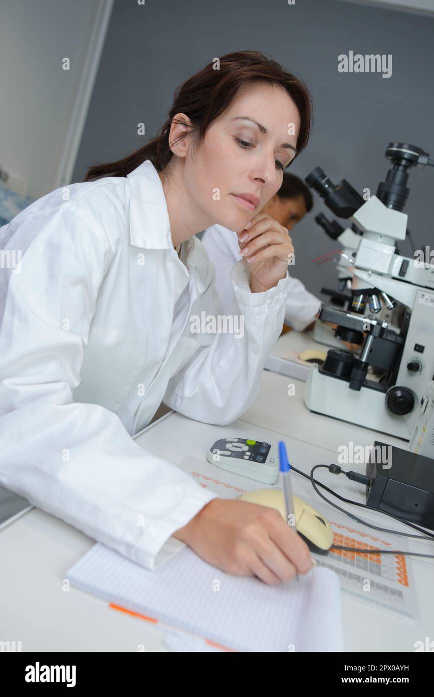 Laboratory technician making notes Stock Photo - Alamy
