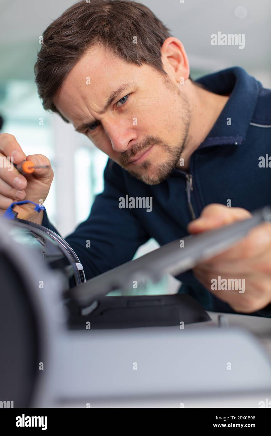 hardware repairman repairing broken printer fax machine Stock Photo - Alamy