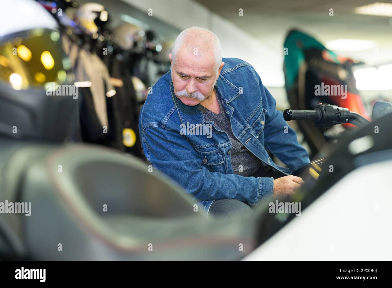 senior man in motorcycle showroom Stock Photo - Alamy