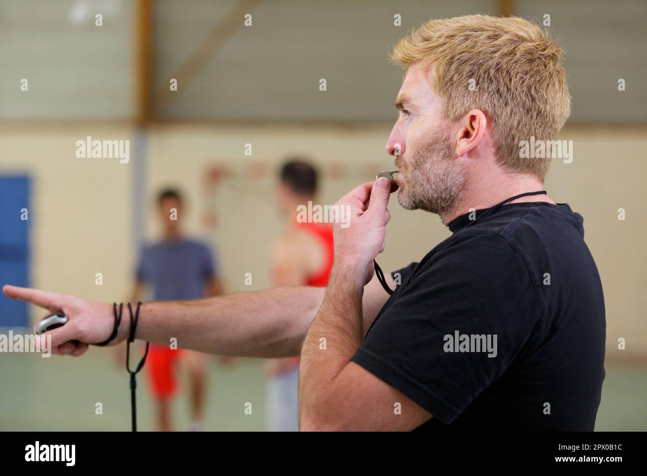 soccer referee whistling in whistle on soccer pitch during game Stock ...