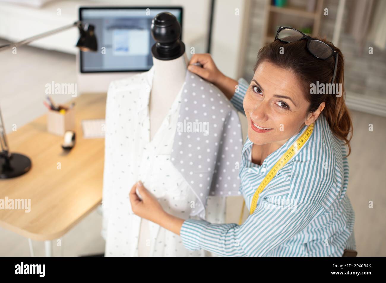 tailor woman checking new sewn jacket on manequin Stock Photo - Alamy