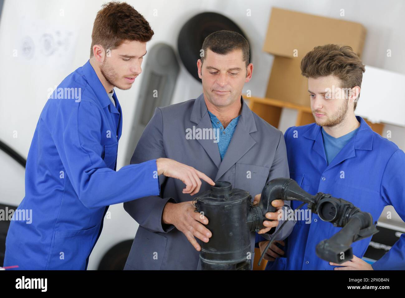 car mechanic learning at a car repair shop Stock Photo - Alamy