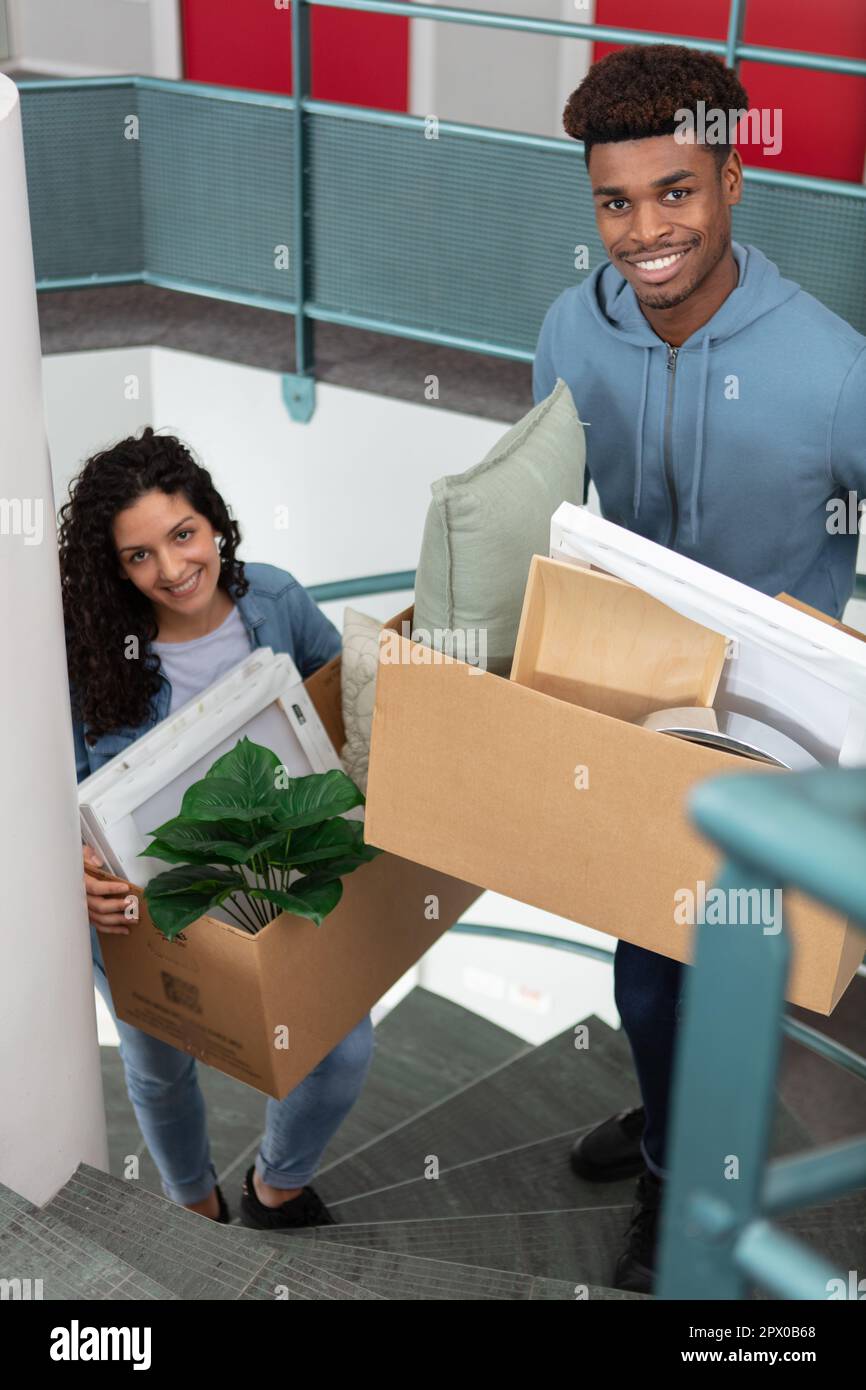 Couple carrying boxes up stairs hi-res stock photography and images - Alamy