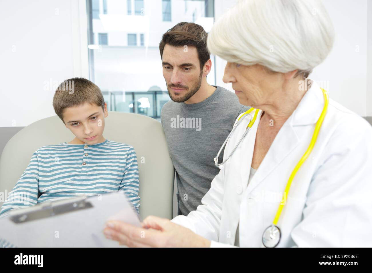 father and son visiting doctor together Stock Photo - Alamy