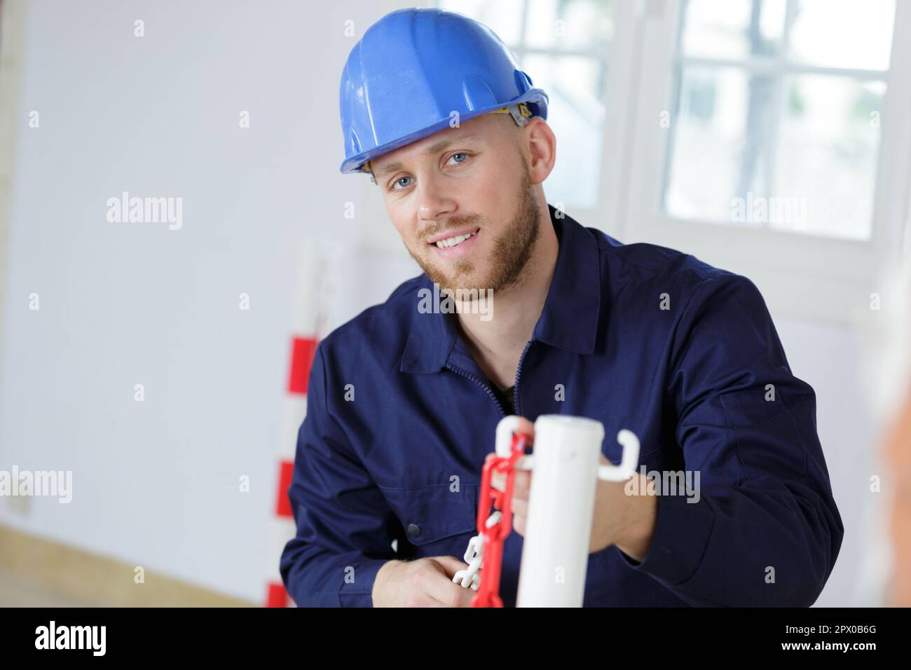 a happy builder is indoors Stock Photo - Alamy