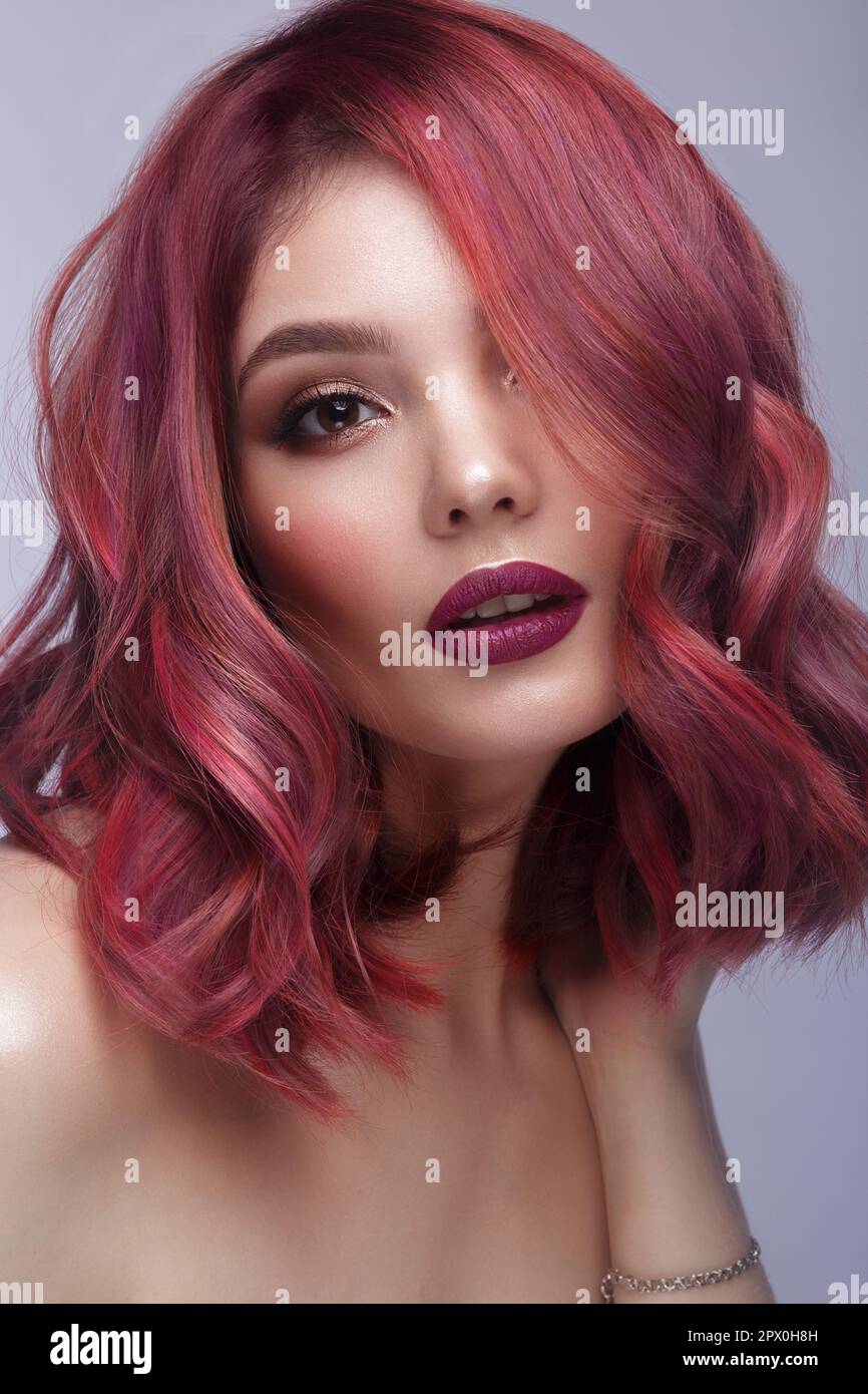 Beautiful girl with multi-colored hair and classic make-up and ...