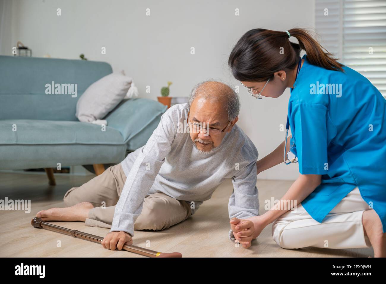 Asian older senior man falling down on lying floor and woman nurse came ...