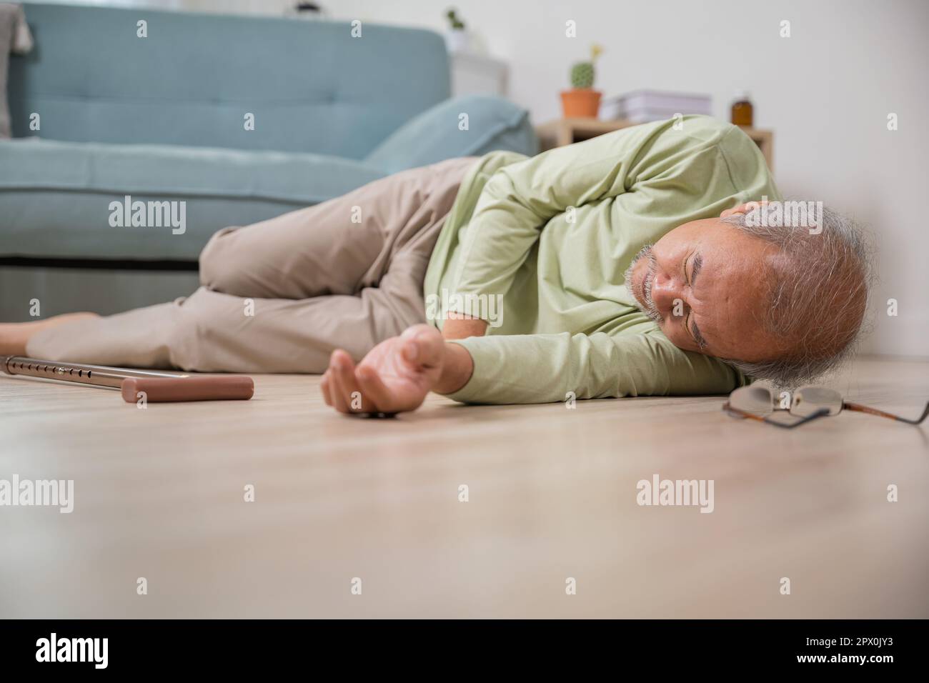 Older senior man headache lying on the floor after falling down he pain ...