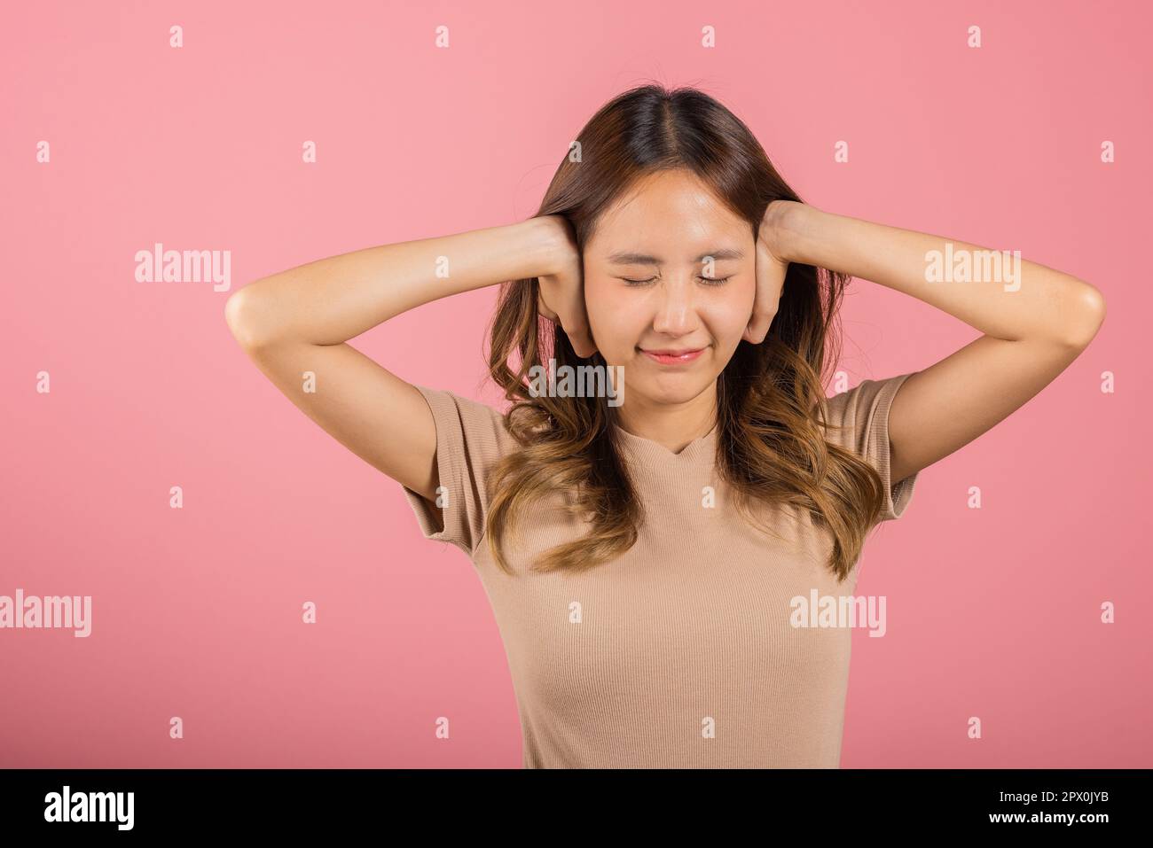 Asian portrait beautiful young woman have close ears with hand palms ...