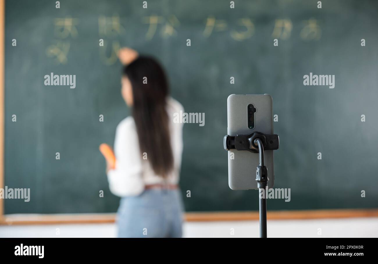 Back to school online class. Asian teacher teach on board while have ...