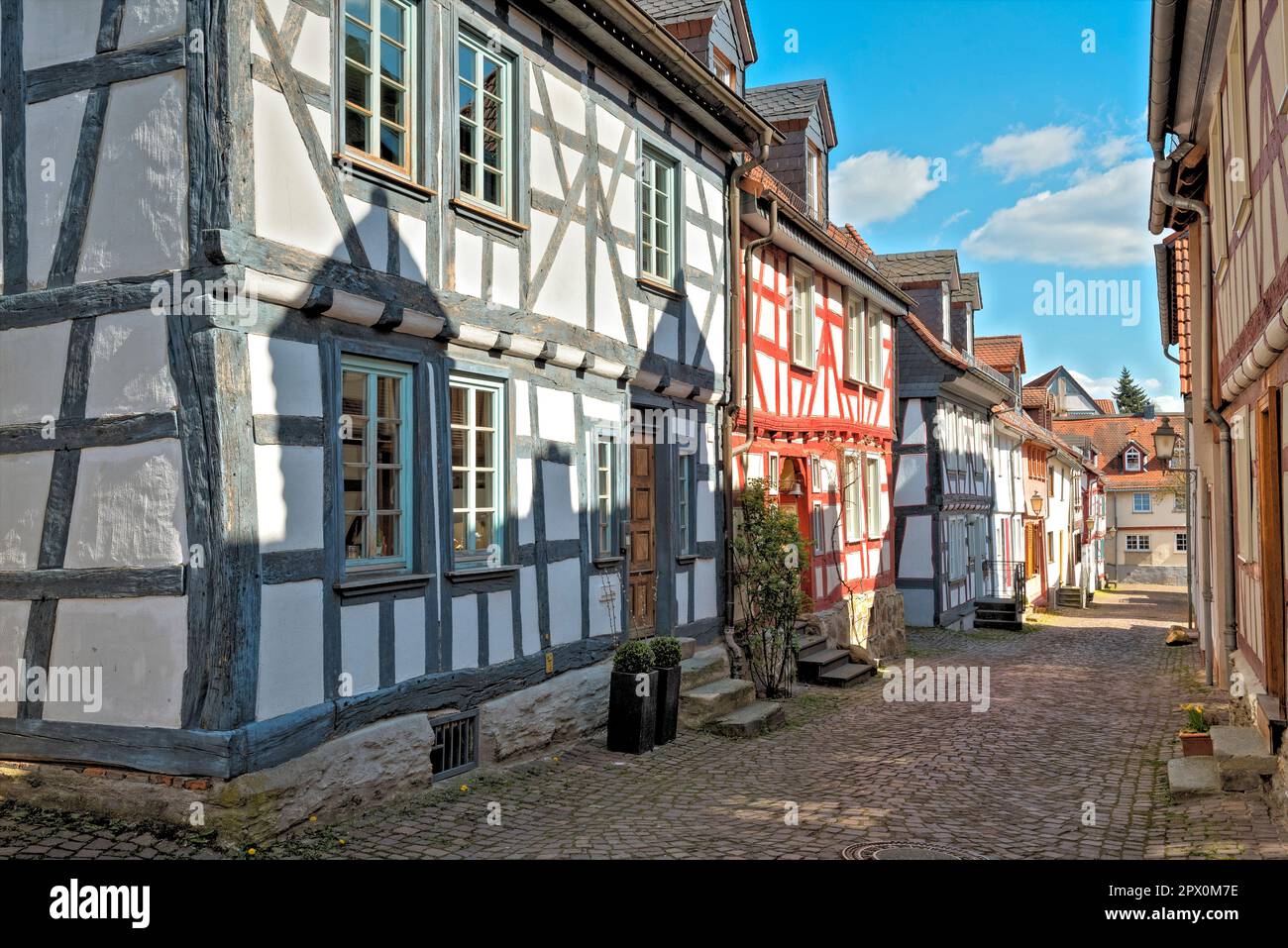 Paved street with renovated half-timbered houses on the edge in the ...