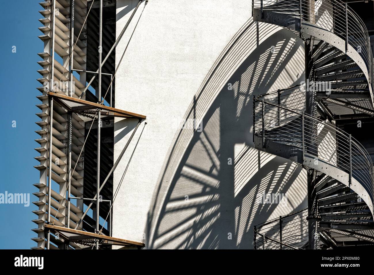 A spiral staircase or fire escape on the outside wall of a building ...