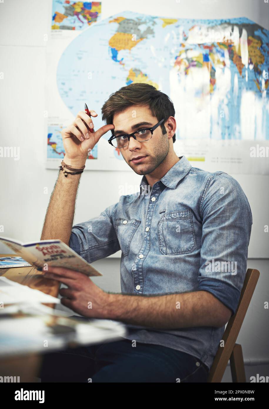 Im spoilt for choice. Cropped portrait of a young man holding a travel ...