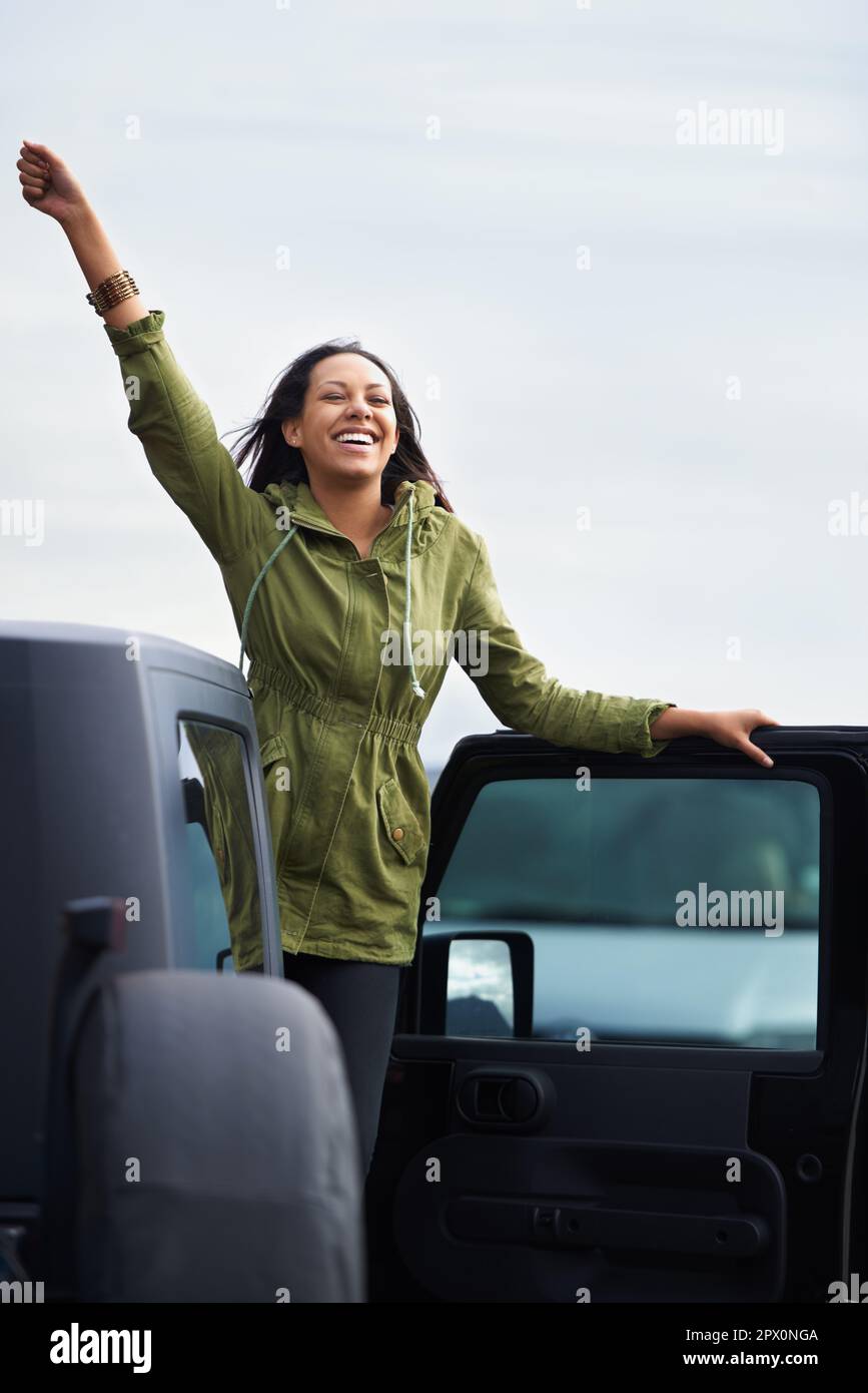 Road trip time. a young woman enjoying the freedom of the road Stock ...