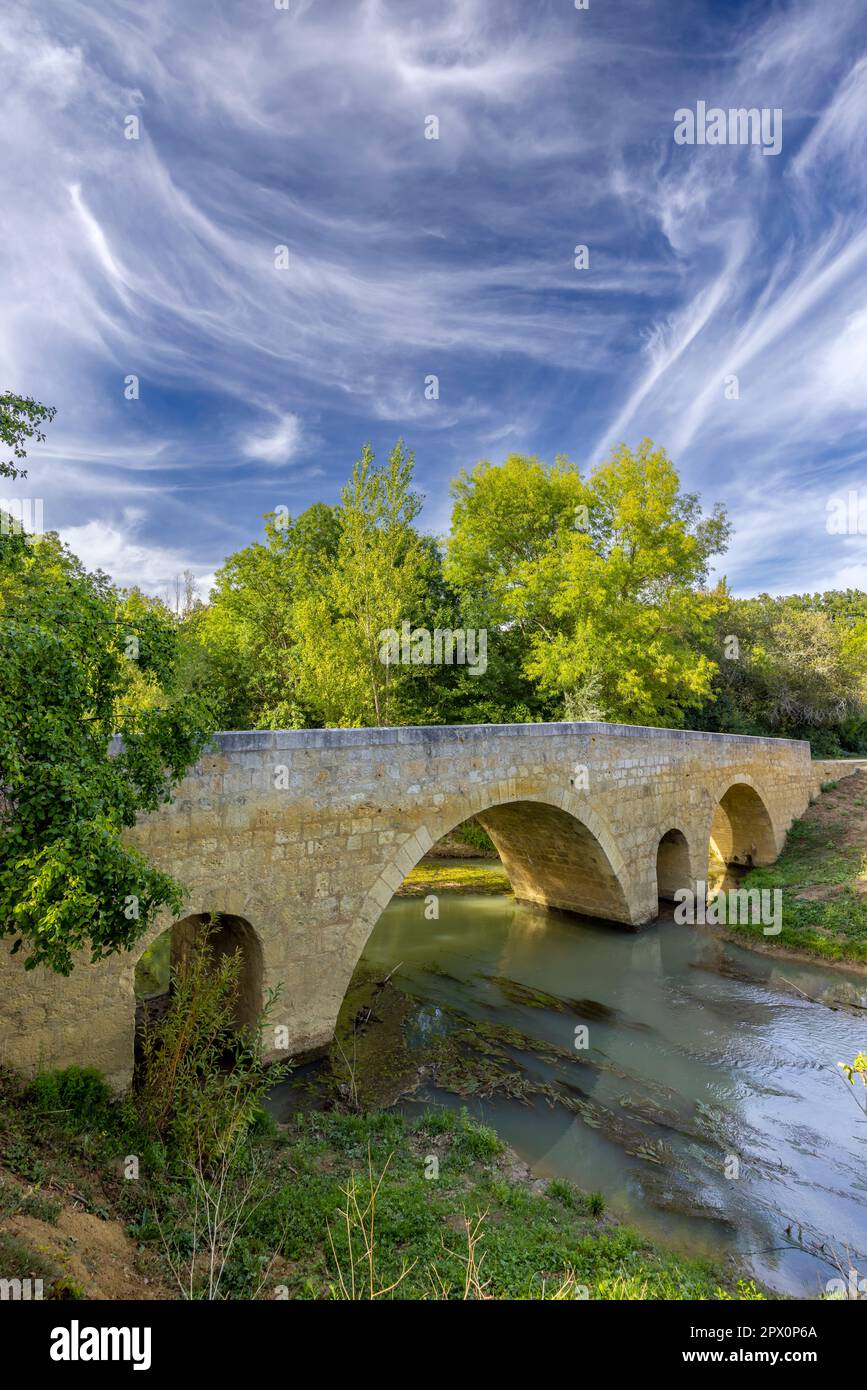 Romanesque bridge of Artigue and river Osse near Larressingle on route ...