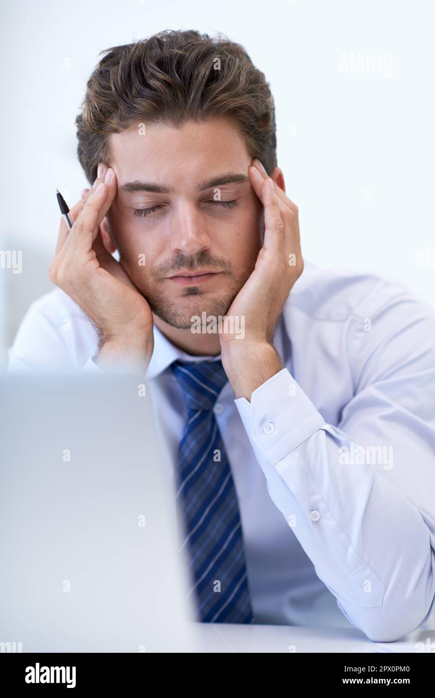 This just gives me one BIG headache. a stressed businessman holding his ...
