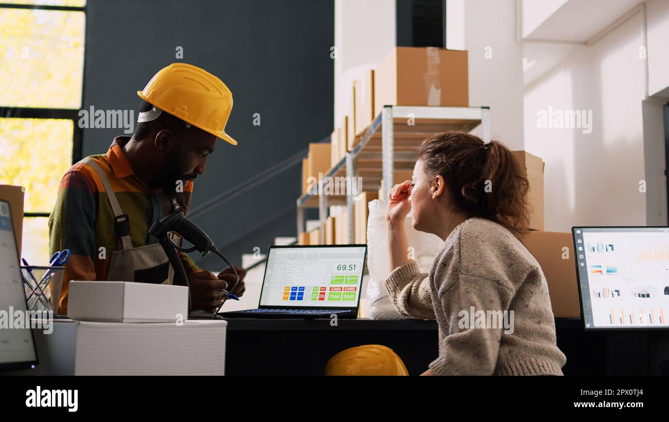 Woman discussing order shipping details with african american colleague ...