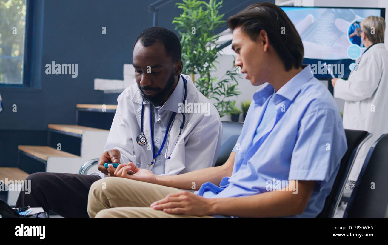 Physician doing insulin level measurement with glucometer to help ...